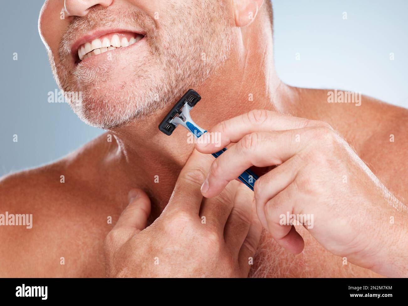 Epilation, razor and man shaving his face in a studio for a facial ...