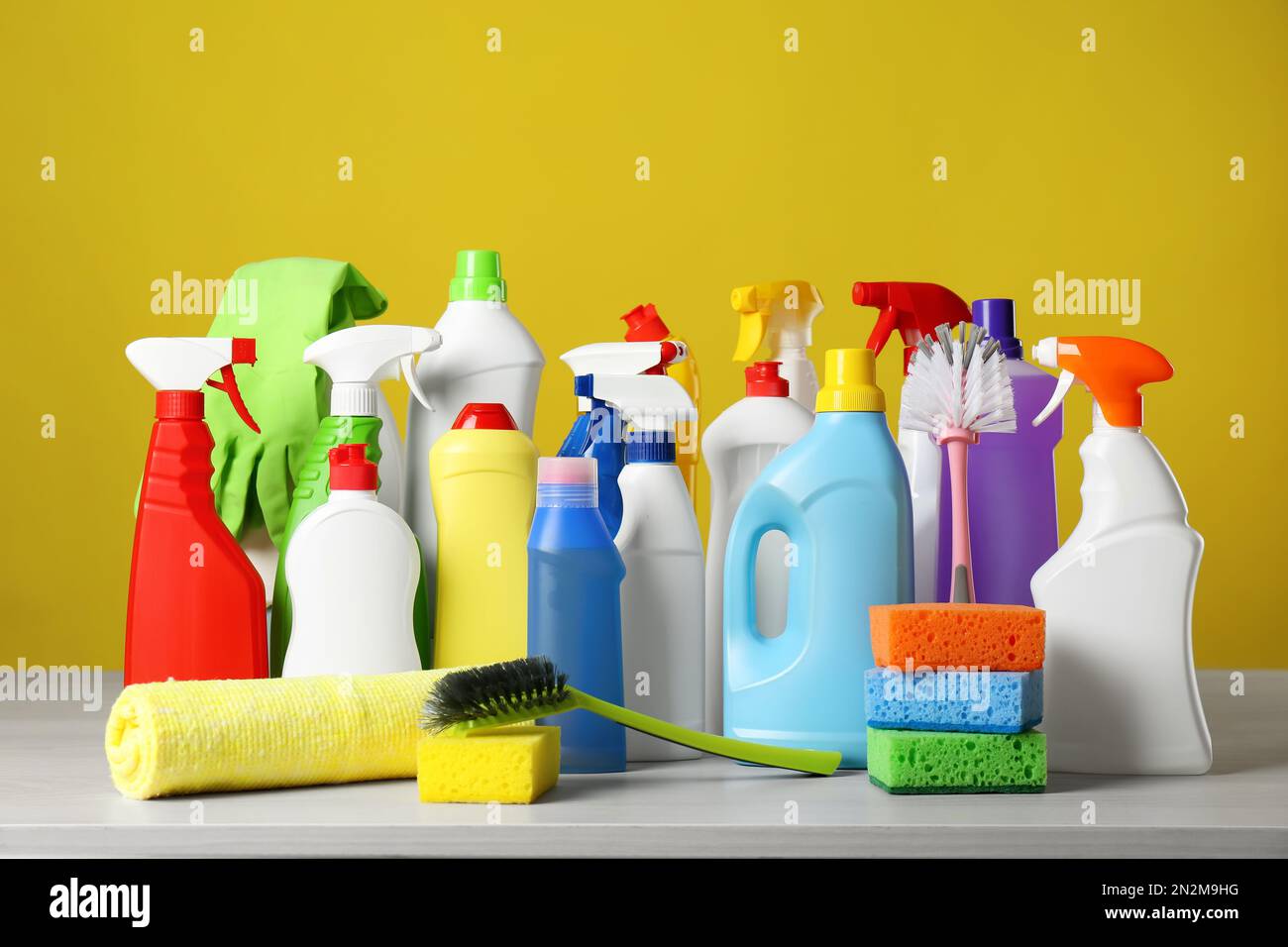 Different cleaning products and supplies on light table Stock Photo - Alamy