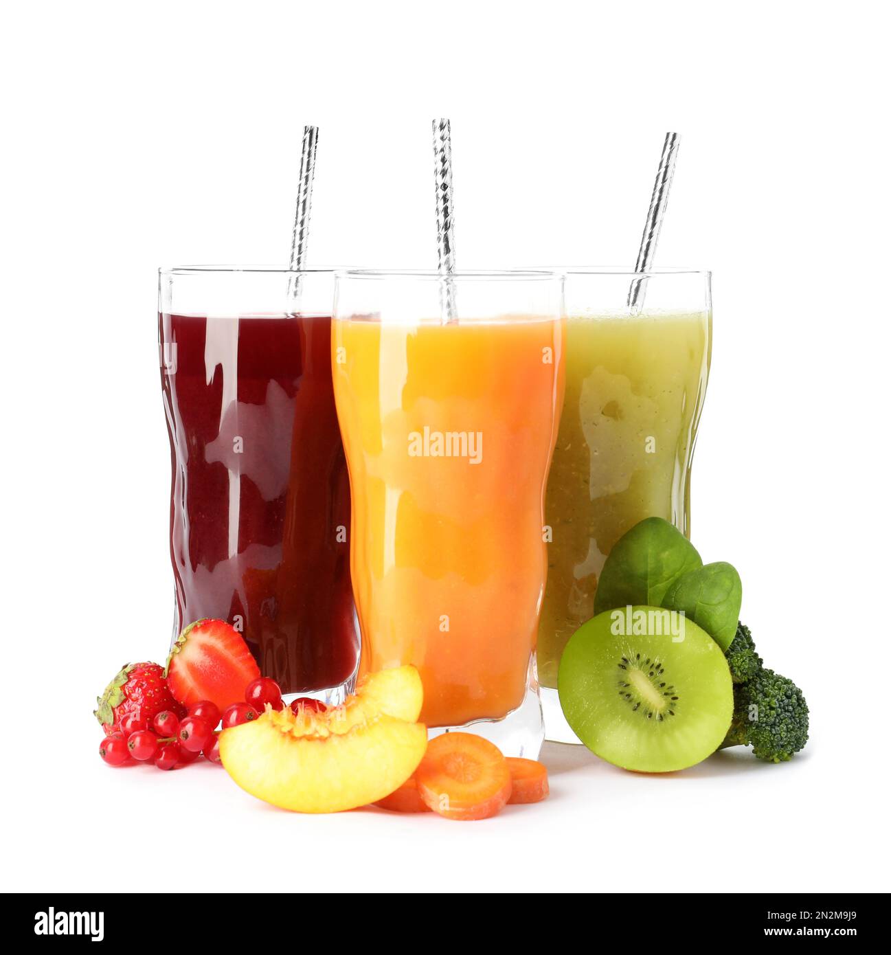 Delicious colorful juices in glasses and fresh ingredients on white ...
