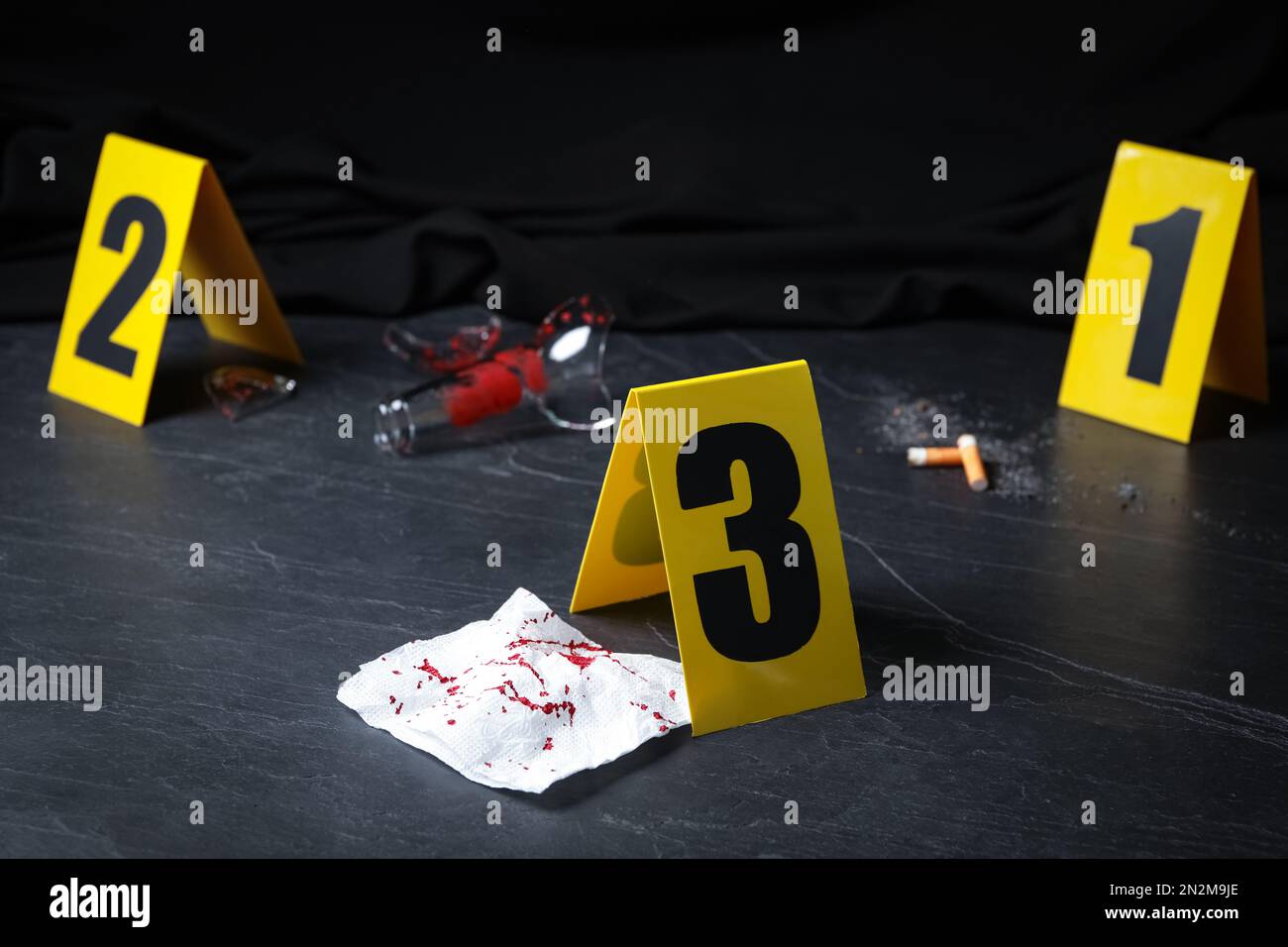 Bloody napkin and crime scene marker on black slate table Stock Photo ...
