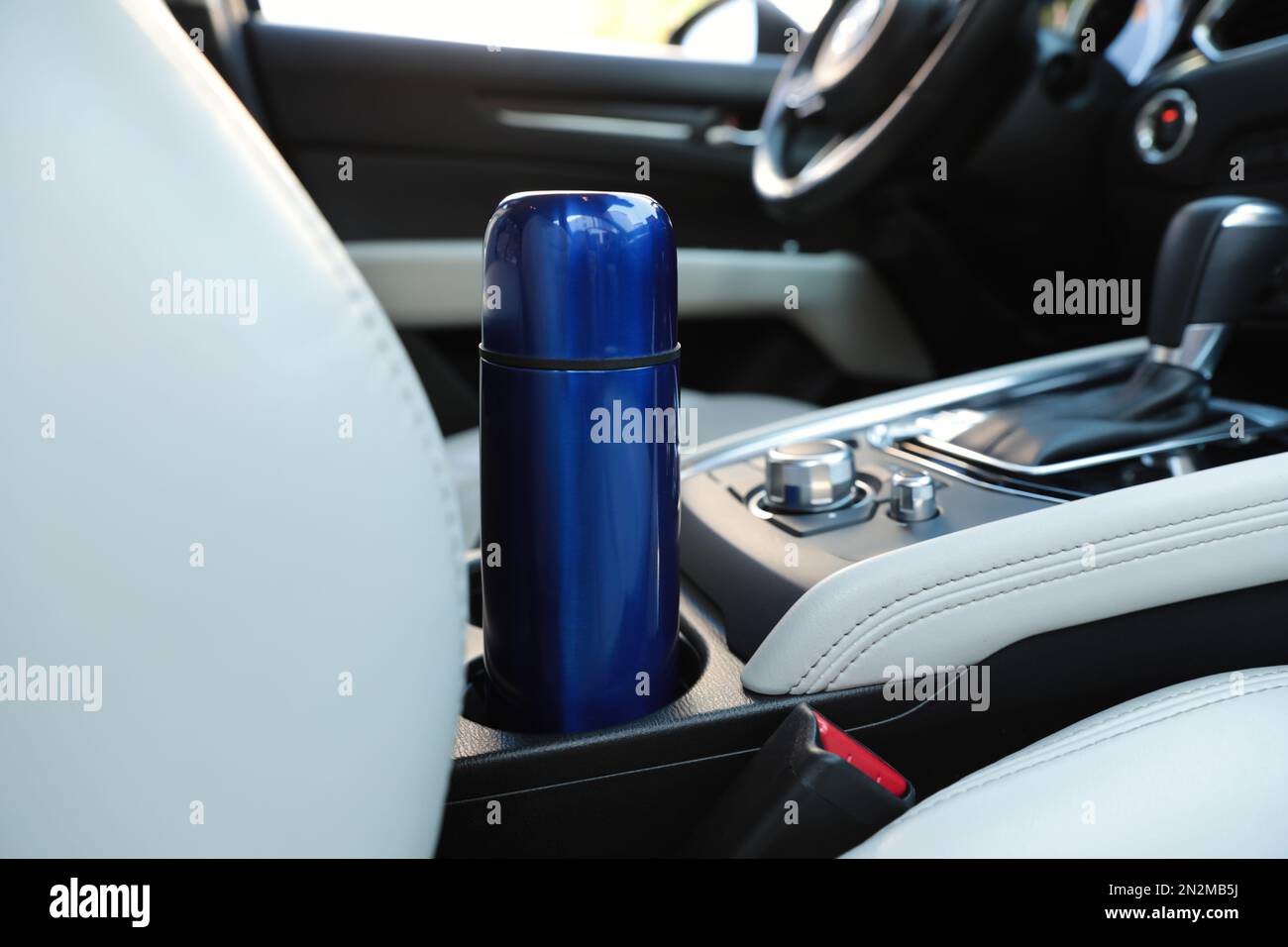 Blue thermos in holder inside of car Stock Photo - Alamy
