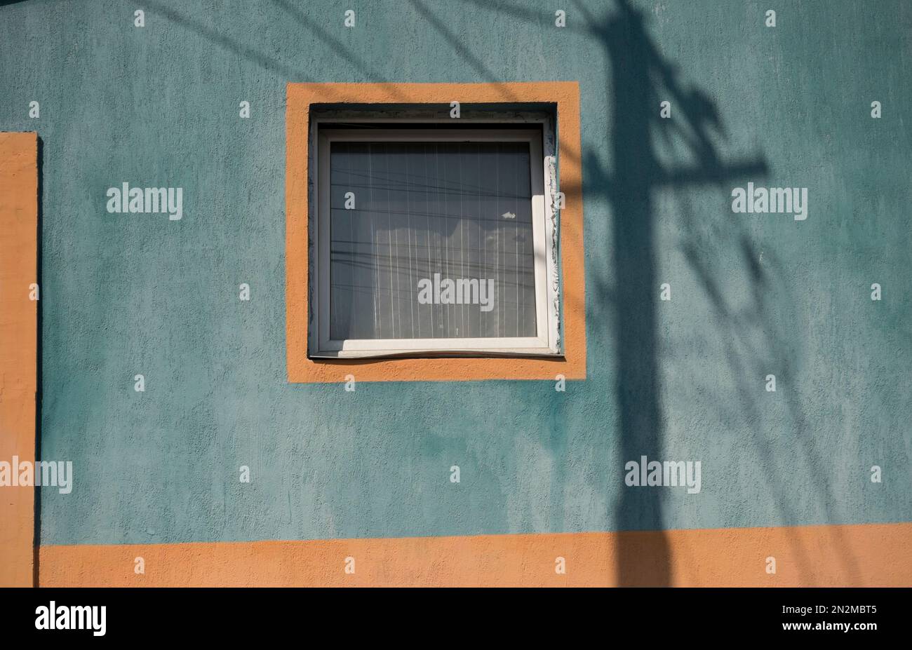 Orange window on a blue house with with pastel colors Stock Photo - Alamy