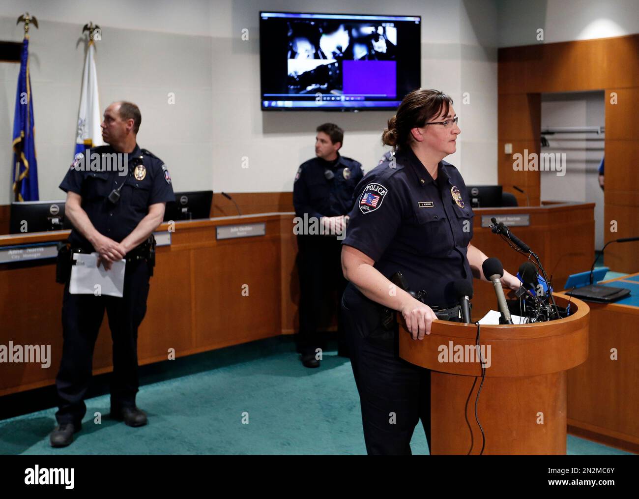 Police officers, background, watch a video monitor as Crystal Police ...