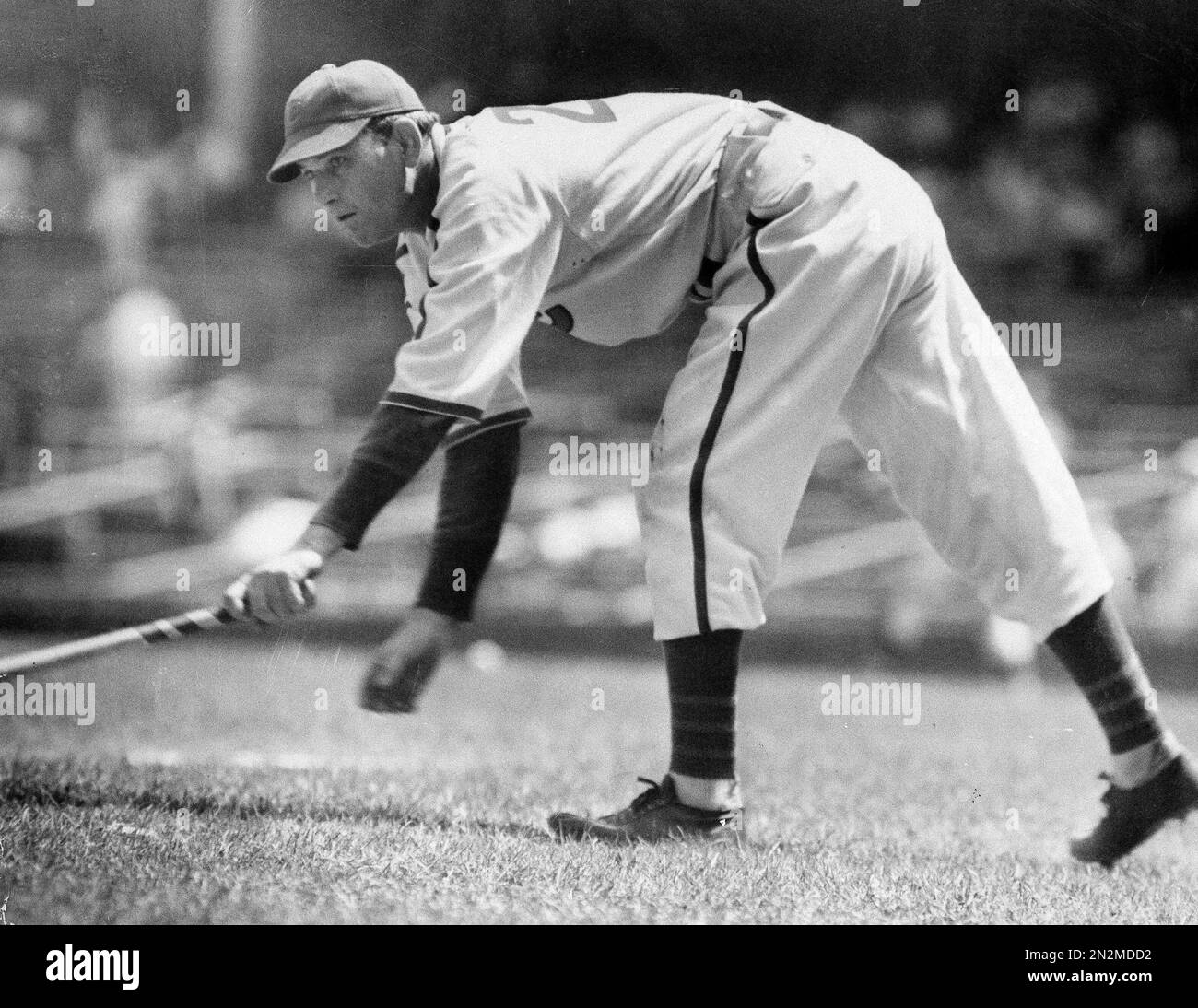 The great Dizzy Dean of the Chicago Cubs bends low to take a crack at ...