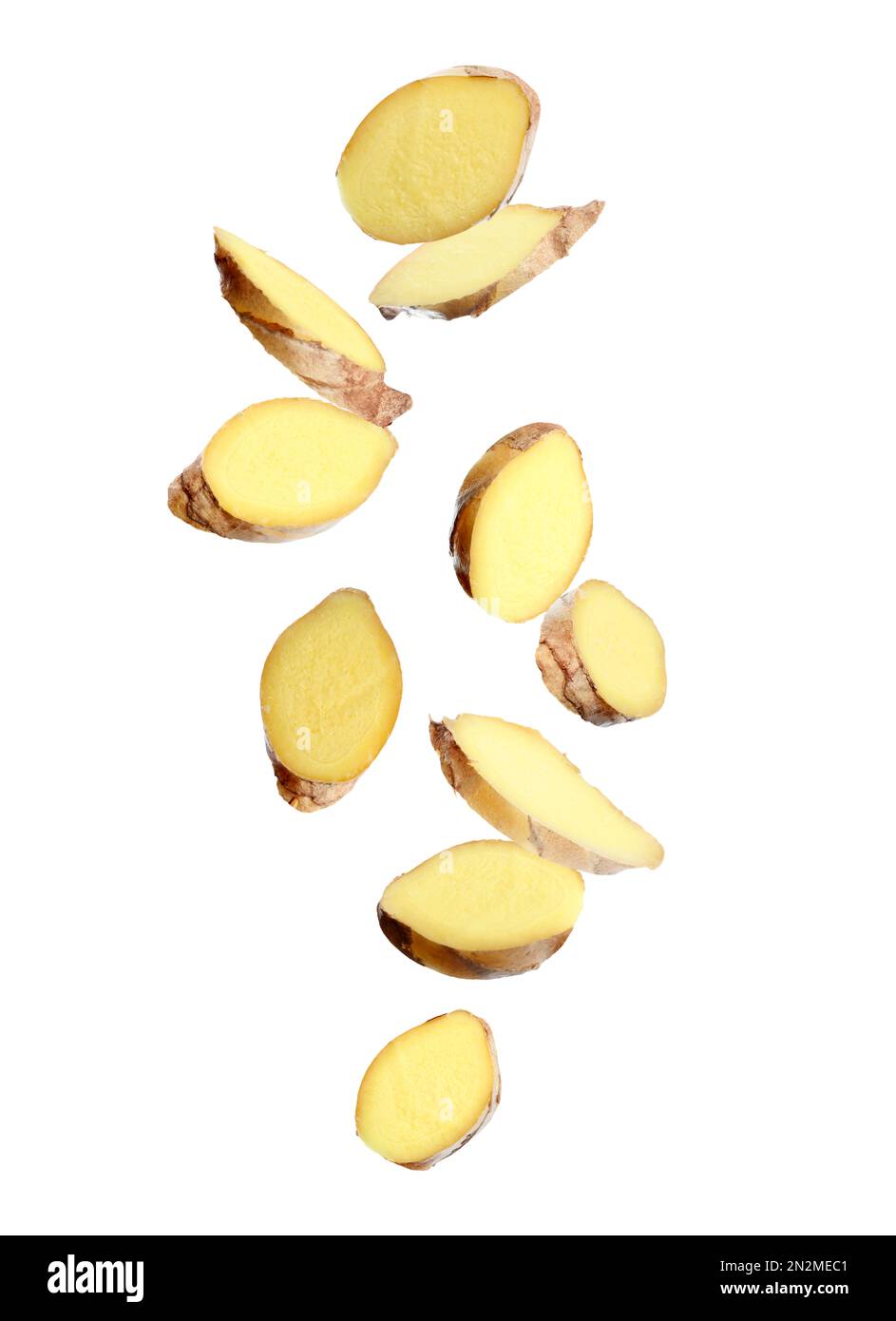 Fresh sliced ginger falling on white background Stock Photo - Alamy