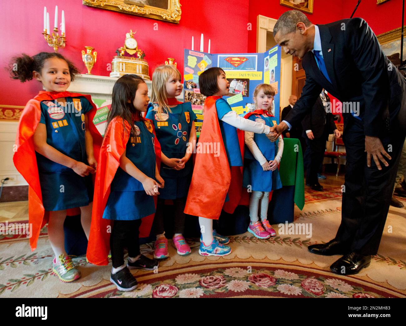 Dressed in super hero capes, six-year-old Girl Scouts, from left ...