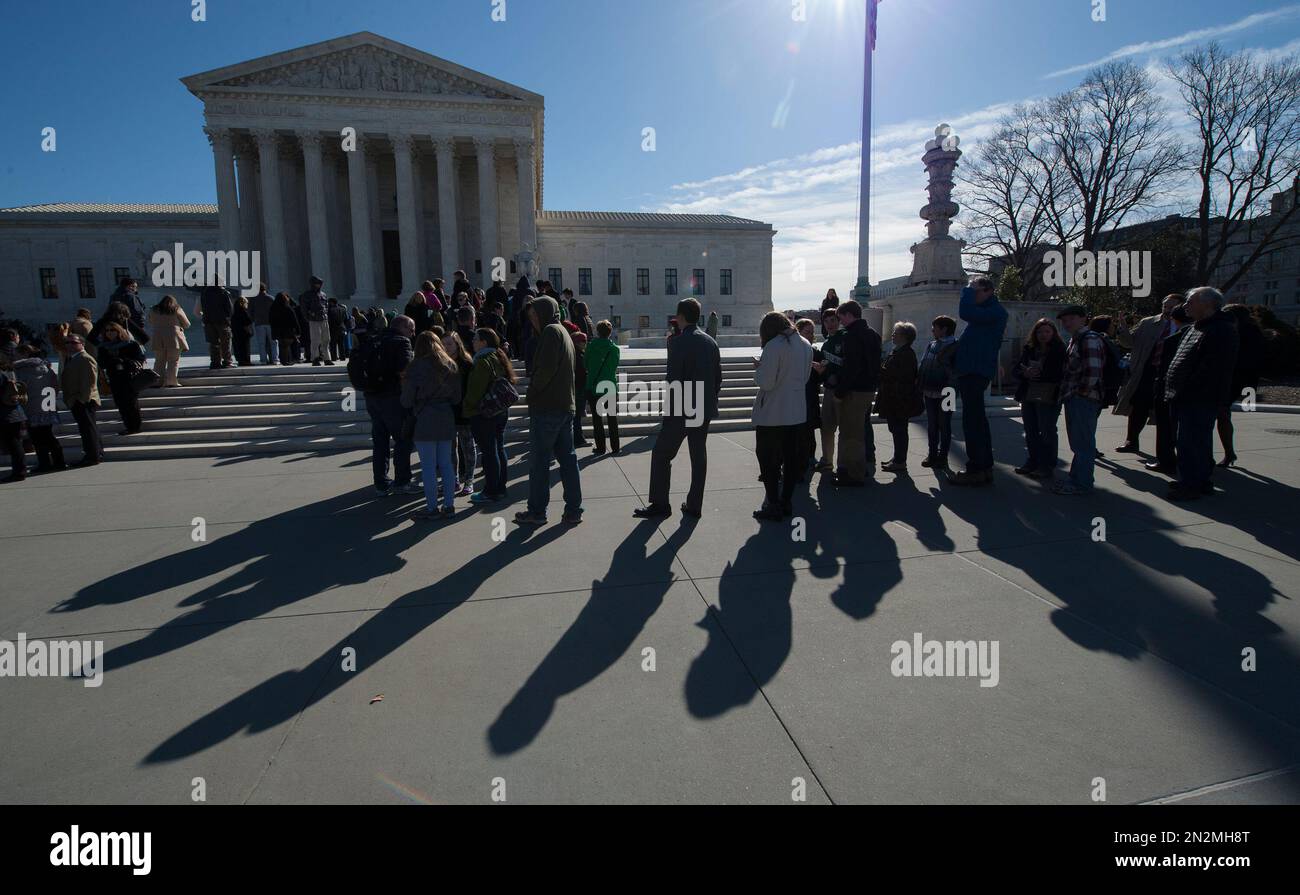 People wait outside the Supreme Court in Washington, Monday, March 23 ...