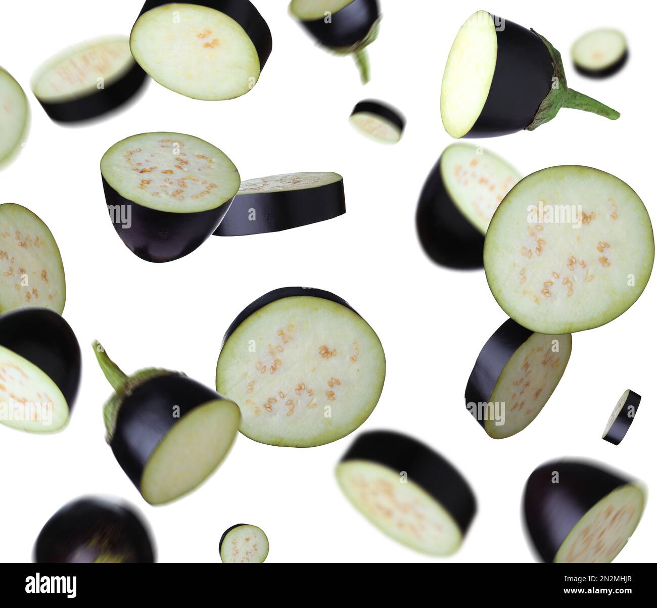 Cut fresh eggplant pieces falling on white background Stock Photo - Alamy