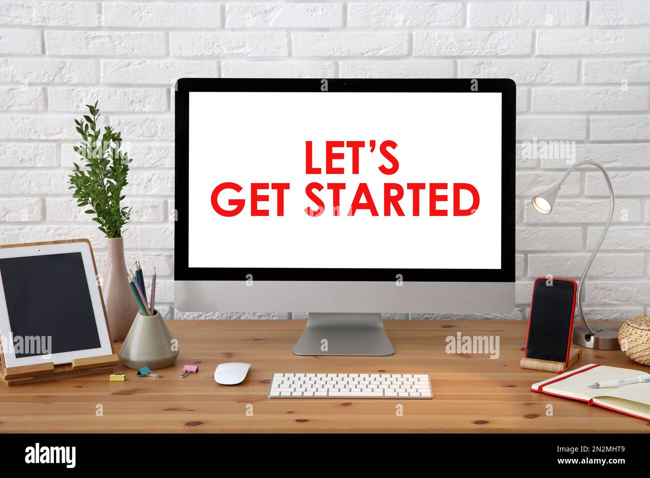 Modern computer monitor with phrase Let's Get started on screen in ...