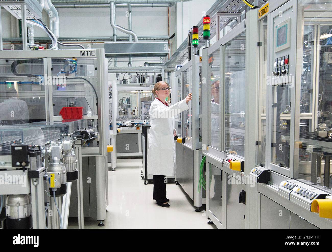 An employee works at an assembly line during the official opening of ...
