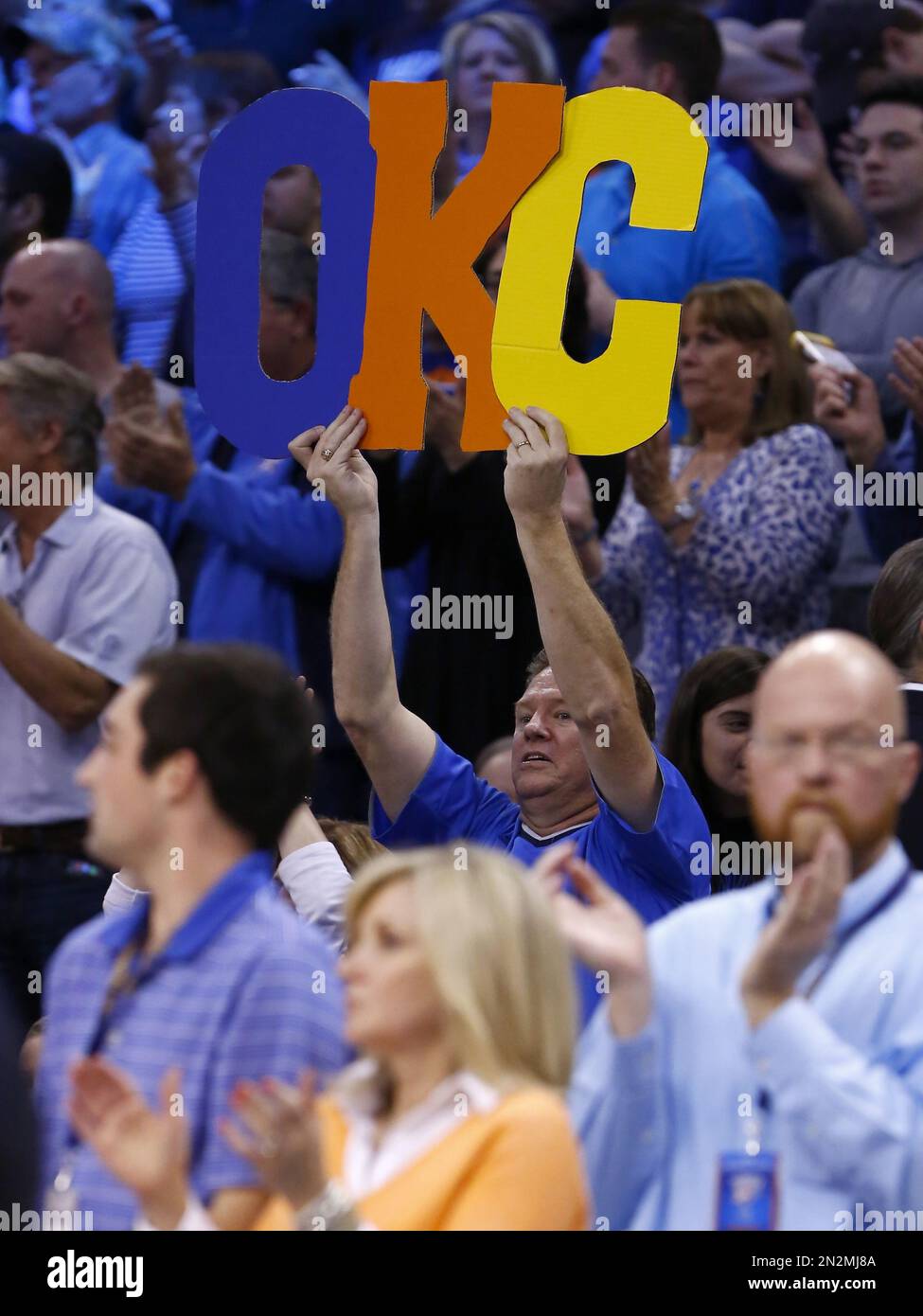An Oklahoma City fan holds an OKC sign up during the fourth quarter of ...