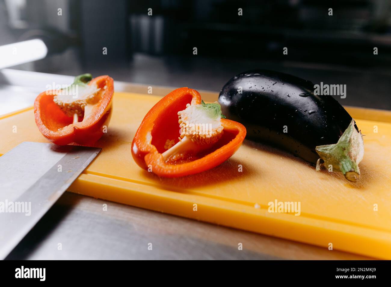 the cook cuts the red pepper. cutting fresh red pepper into strips ...
