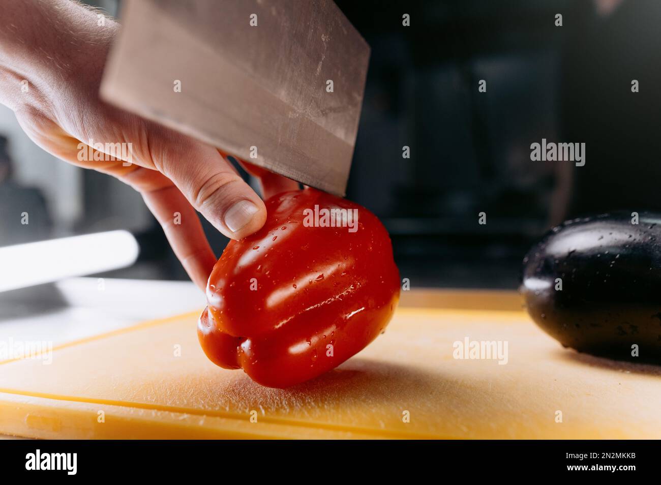 the cook cuts the red pepper. cutting fresh red pepper into strips ...