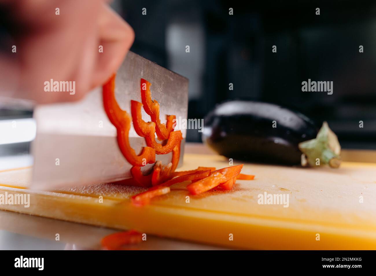 the cook cuts the red pepper. cutting fresh red pepper into strips ...