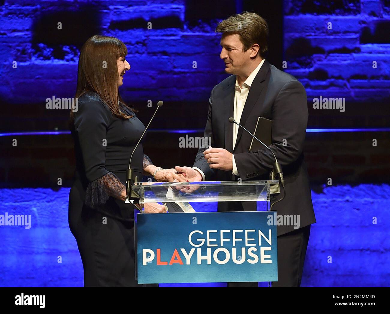 Anjelica Huston, left, and Nathan Fillion speak at Backstage at the ...