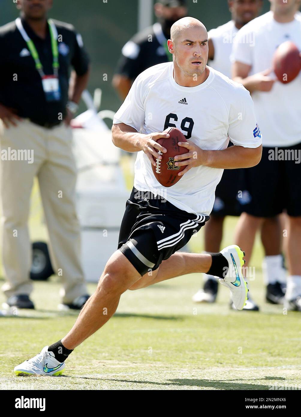 Quarterback Michael Kafka rolls out to pass during the NFL veterans ...