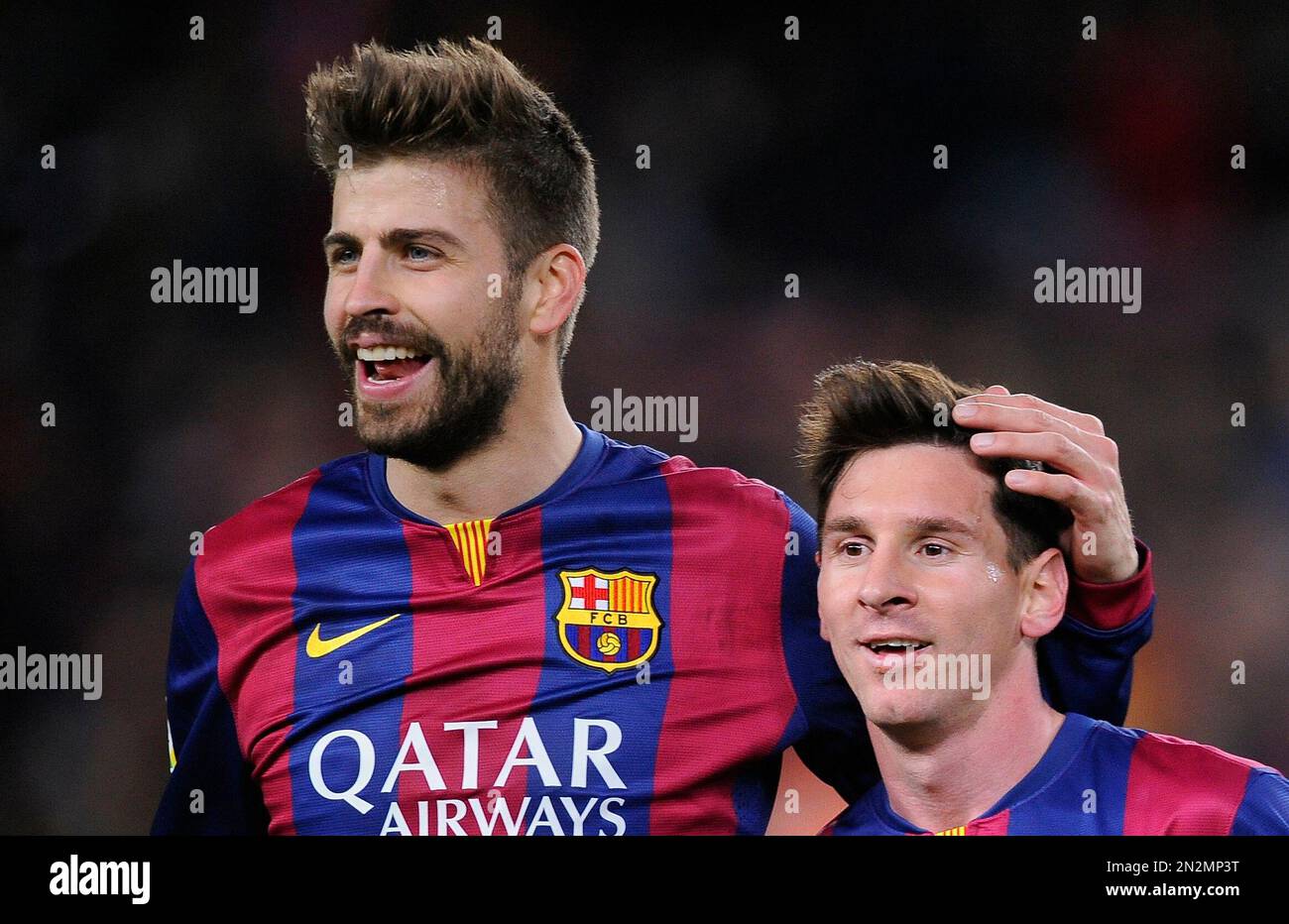 Barcelona's Gerard Pique, left and Lionel Messi leave the field at the ...