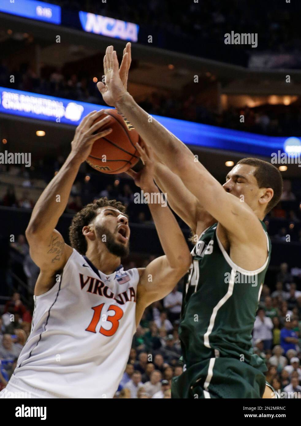 Virginia's Anthony Gill (13) drives against Michigan State's Gavin ...