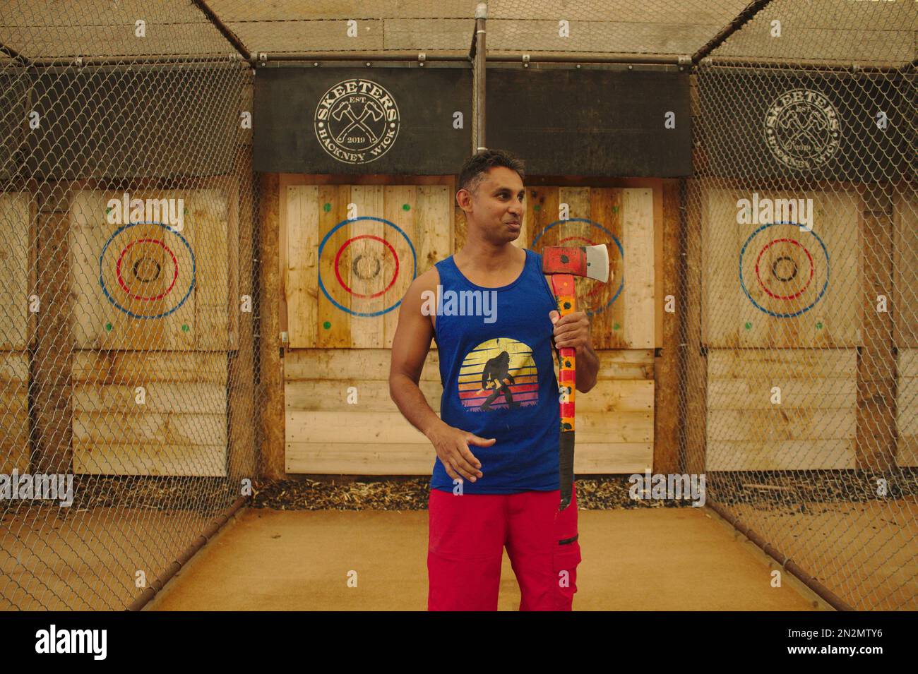 Axe throwing man Stock Photo - Alamy