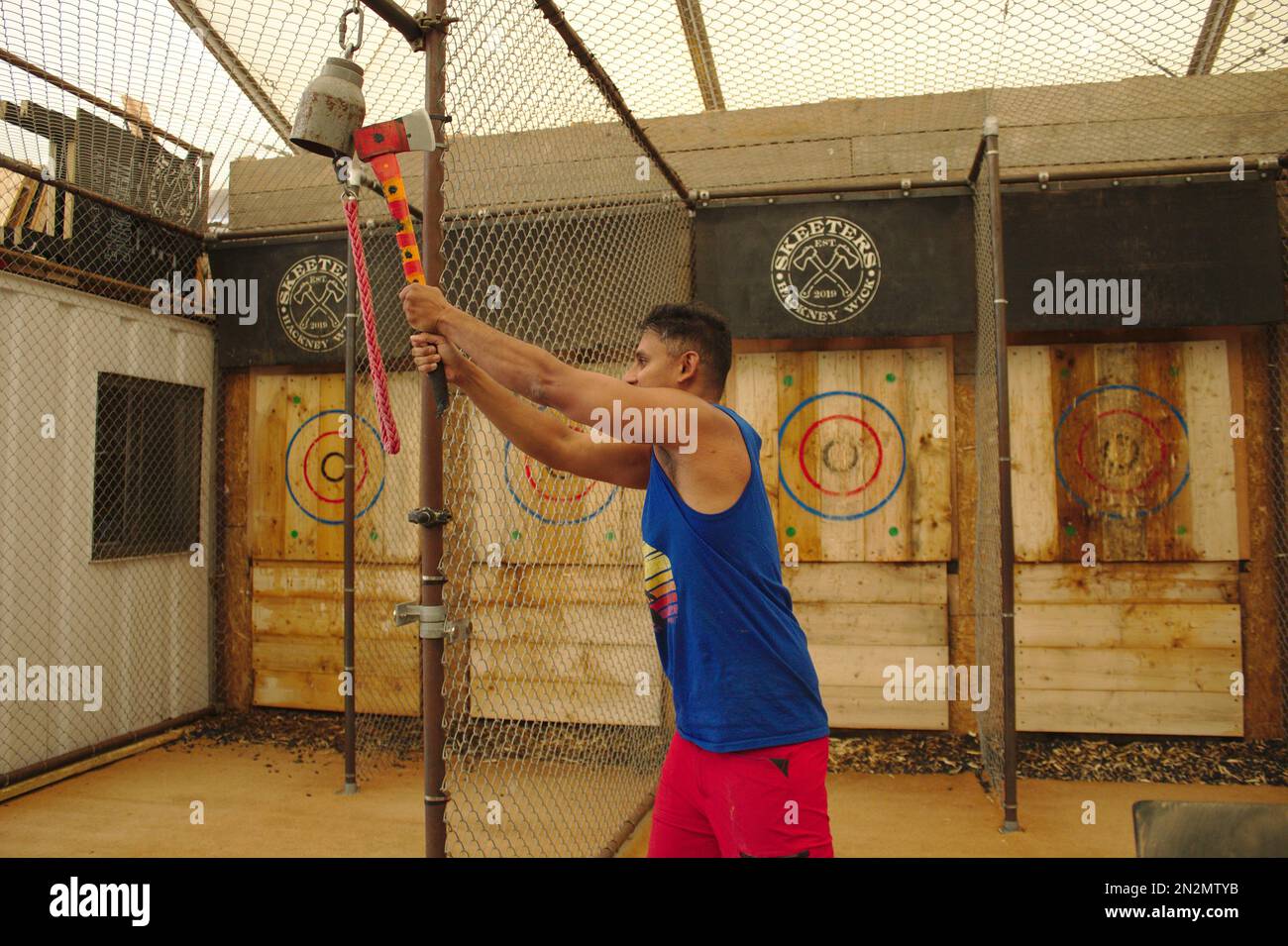 Axe throwing man Stock Photo - Alamy