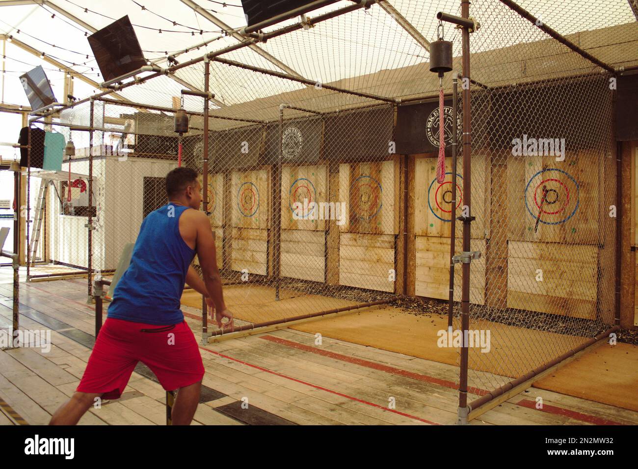 Axe throwing man Stock Photo - Alamy