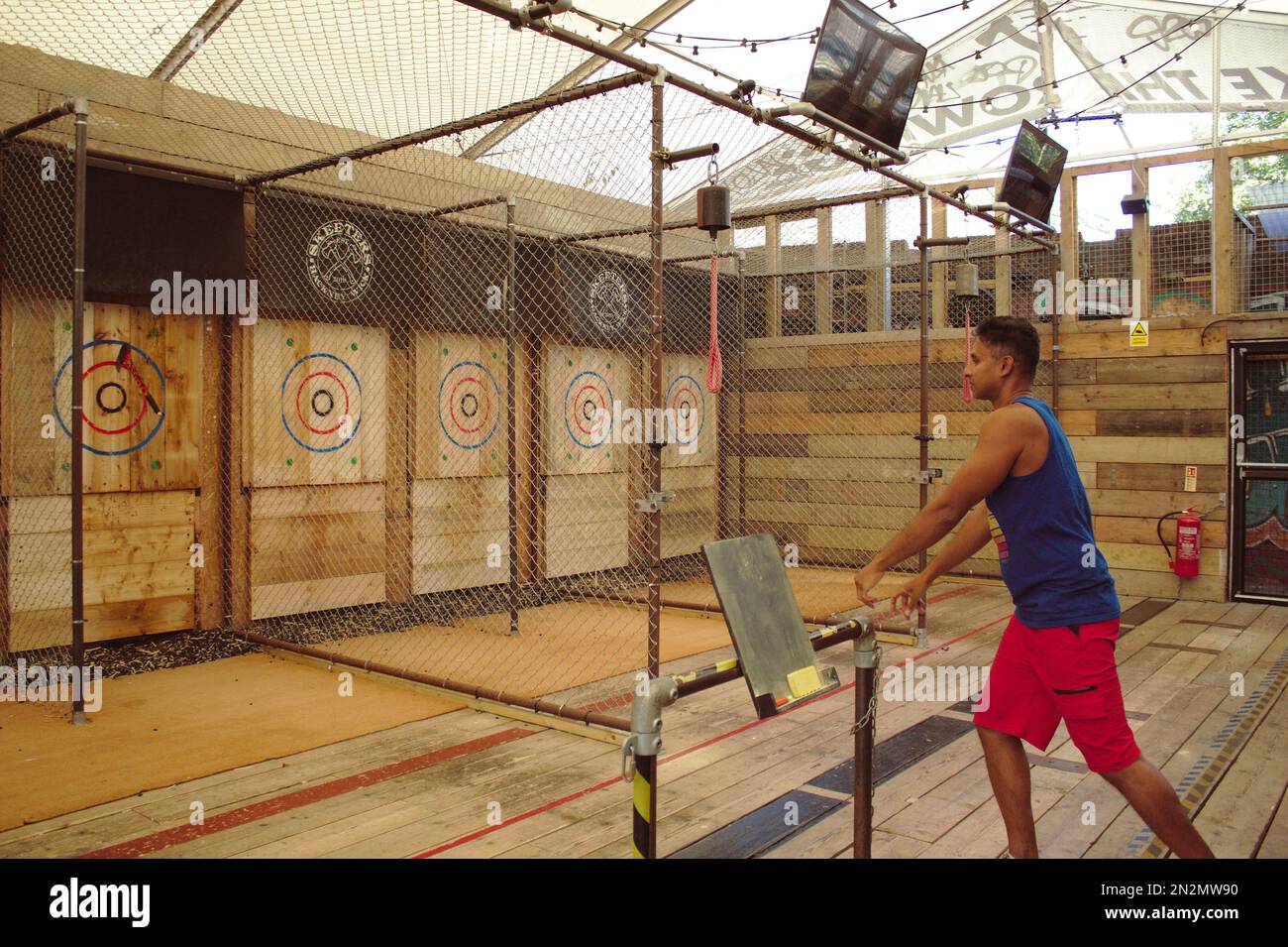 Axe throwing man Stock Photo - Alamy
