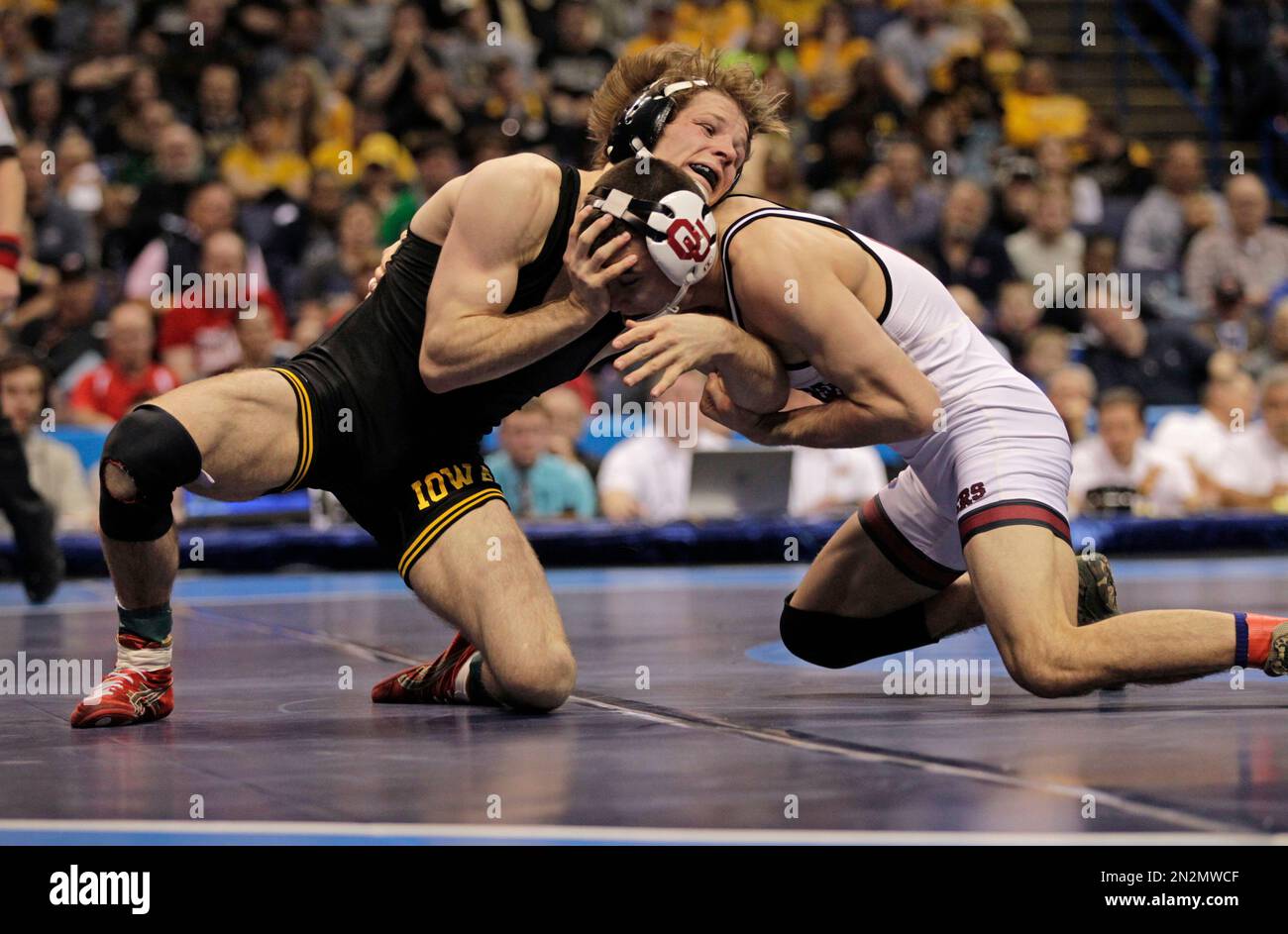 Iowa's Cory Clark, left, wrestles with Oklahoma's Cody Brewer during ...
