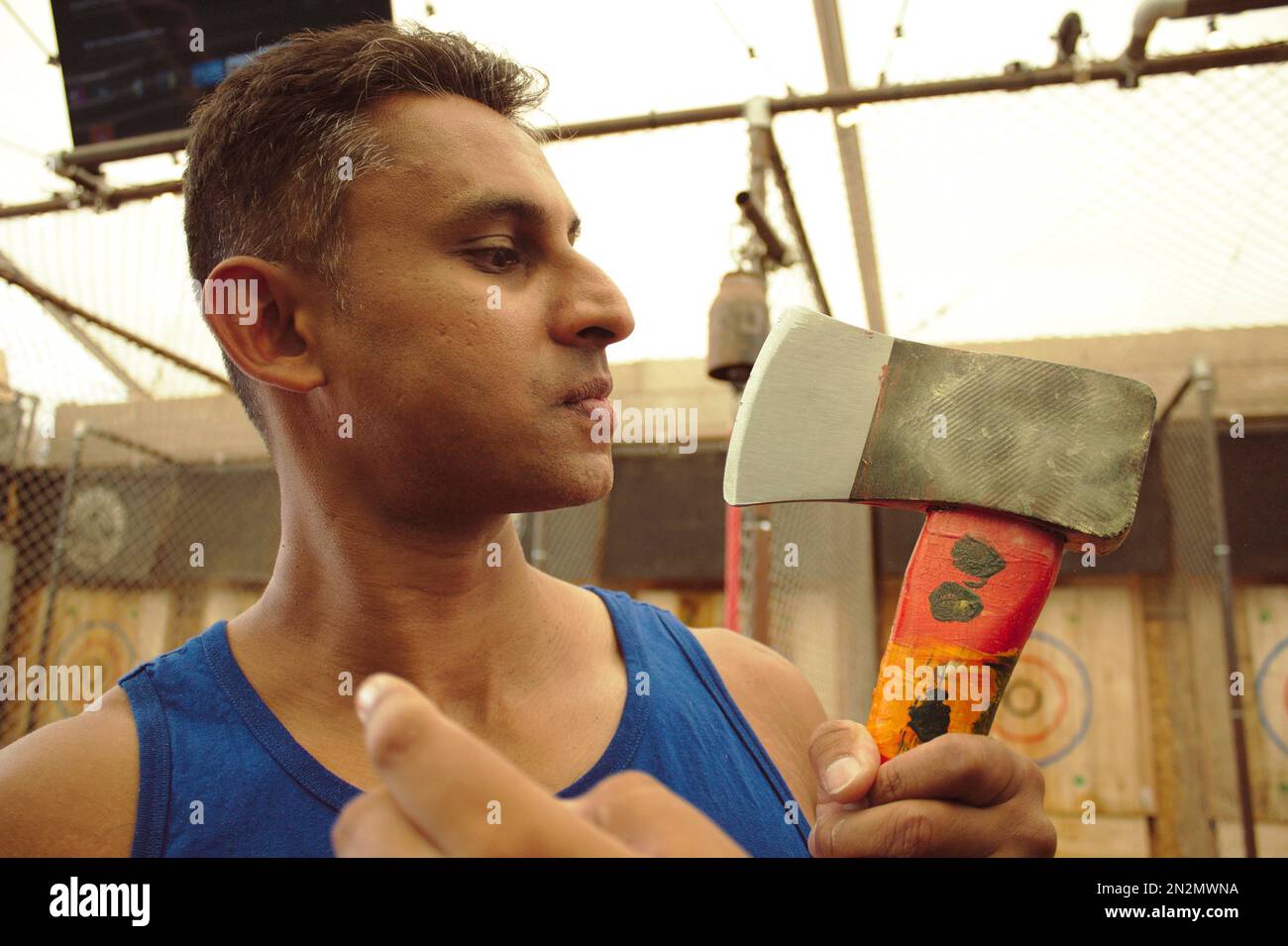 Axe throwing man Stock Photo - Alamy