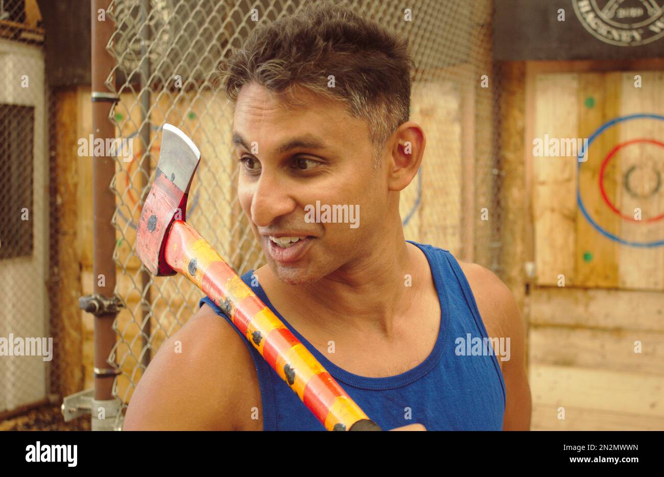 Axe throwing man Stock Photo - Alamy
