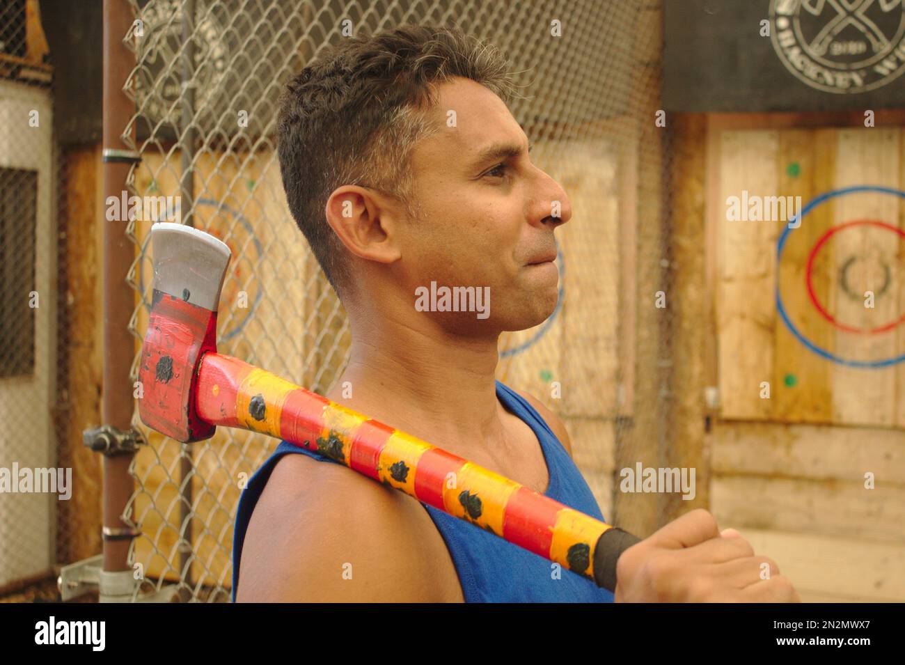 Axe throwing man Stock Photo - Alamy