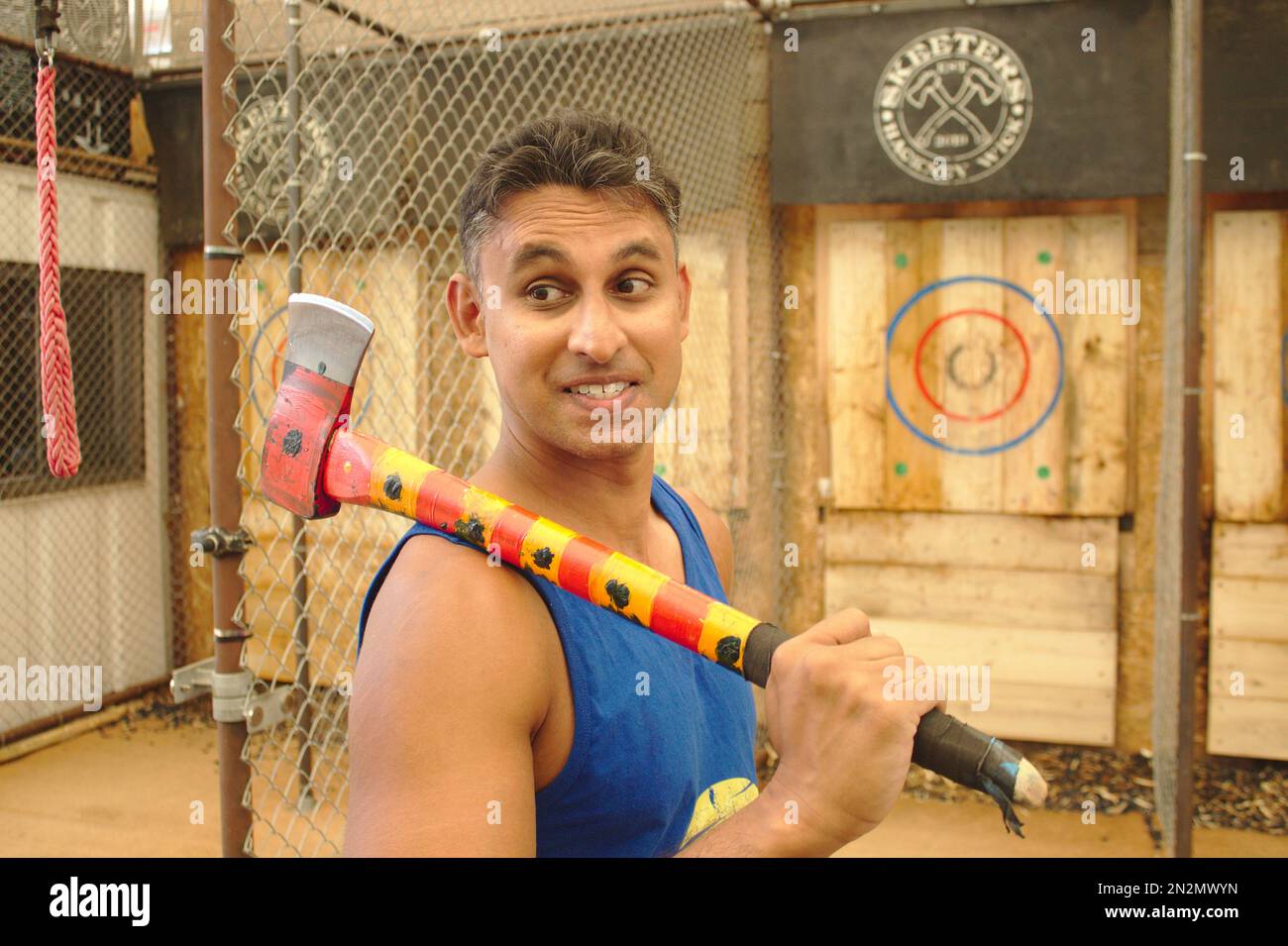 Axe throwing man Stock Photo - Alamy