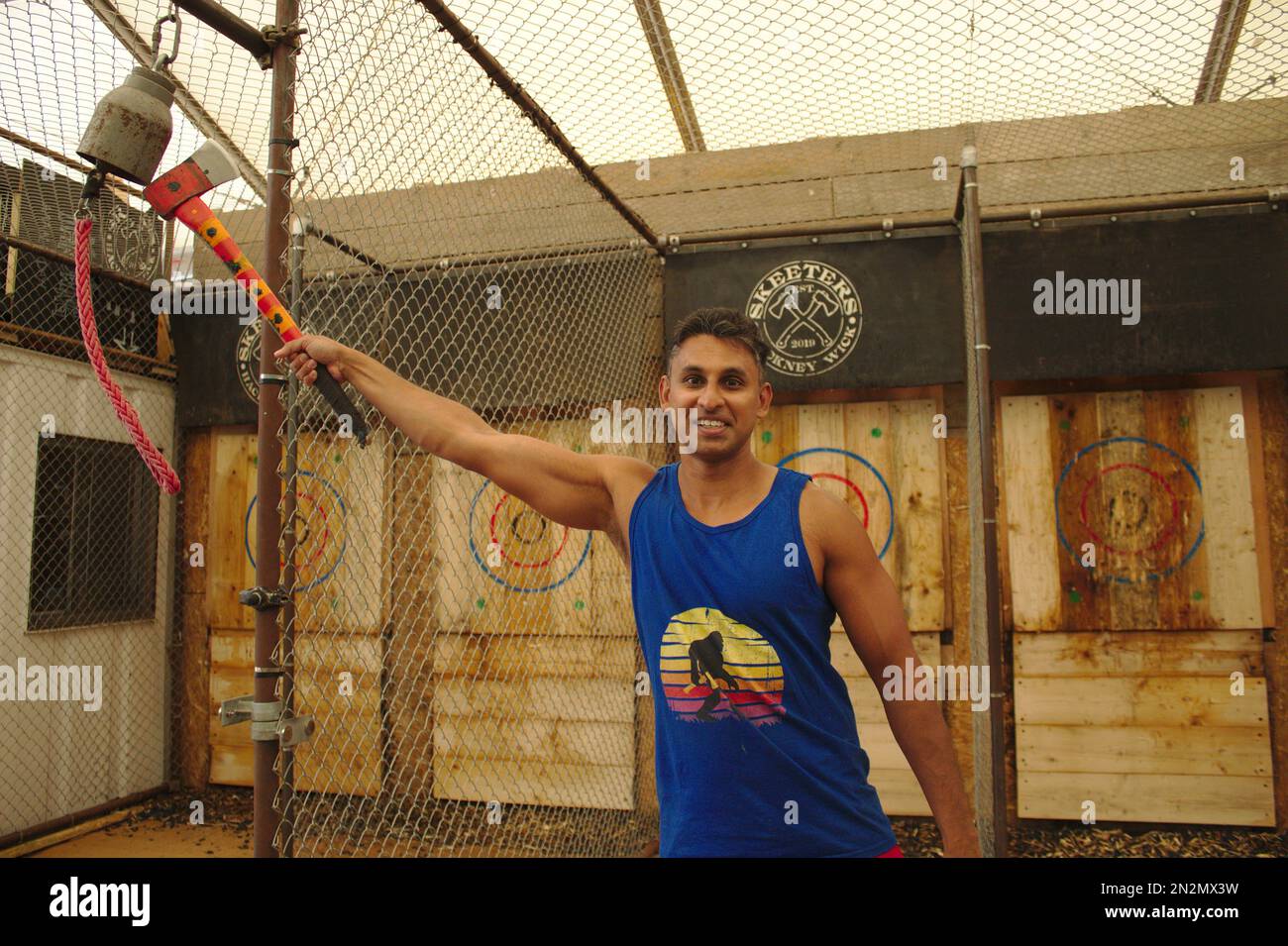 Axe throwing man Stock Photo - Alamy