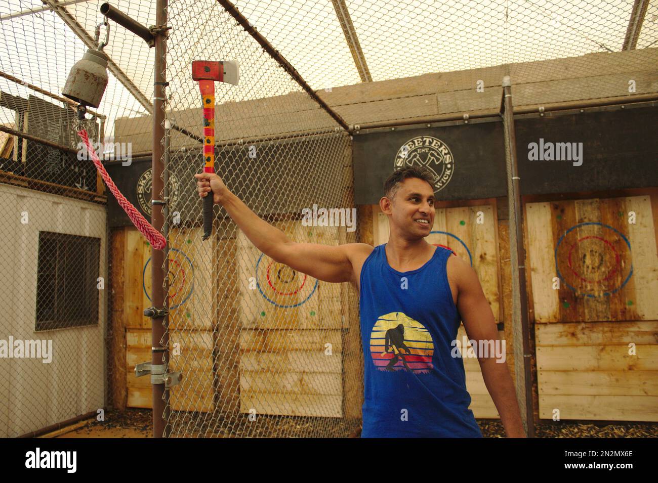 Axe throwing man Stock Photo - Alamy