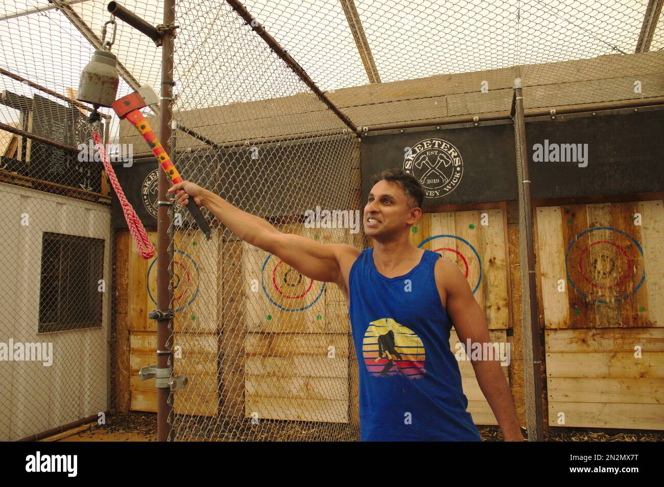 Axe throwing man Stock Photo - Alamy