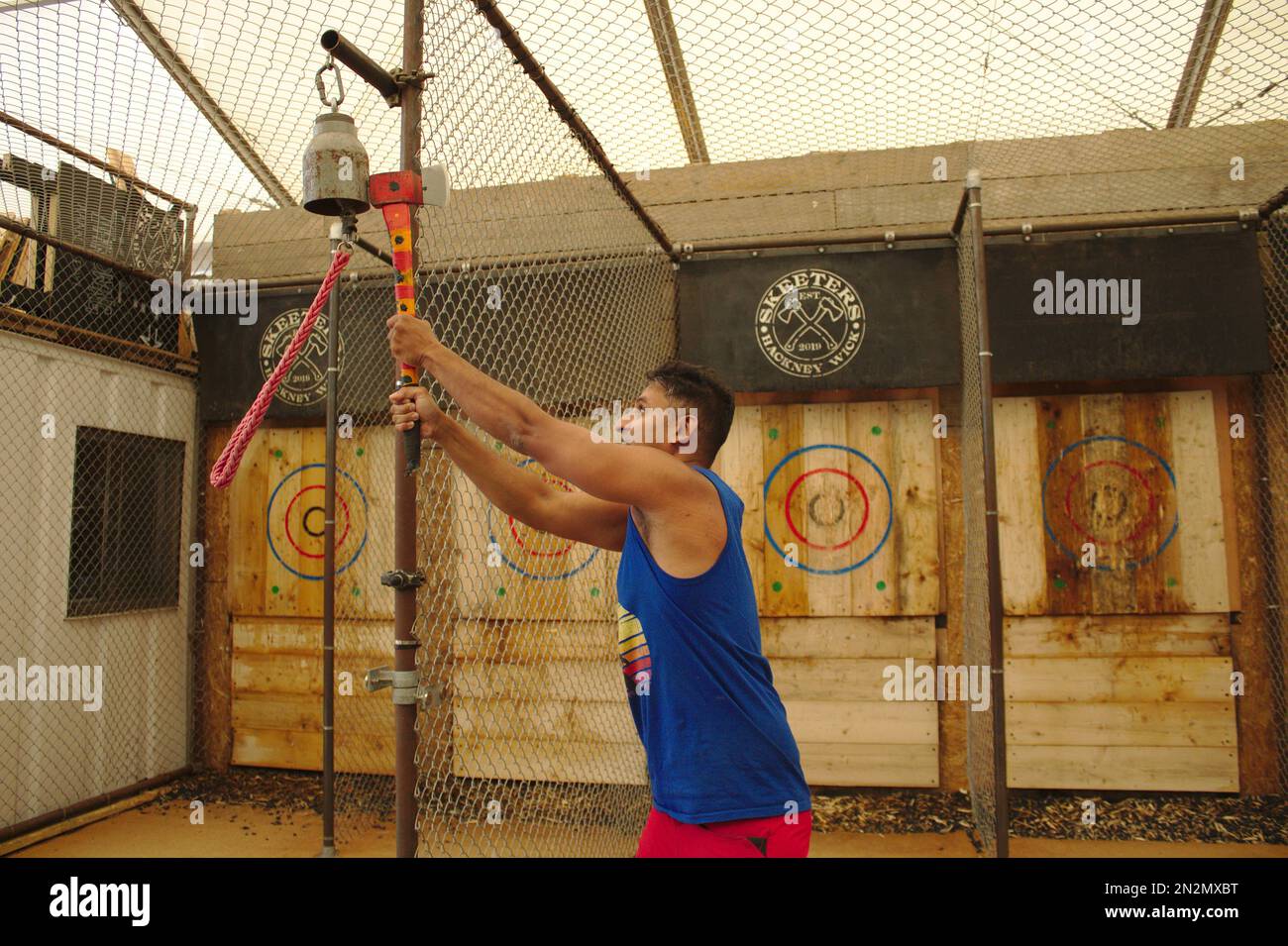 Axe throwing man Stock Photo - Alamy