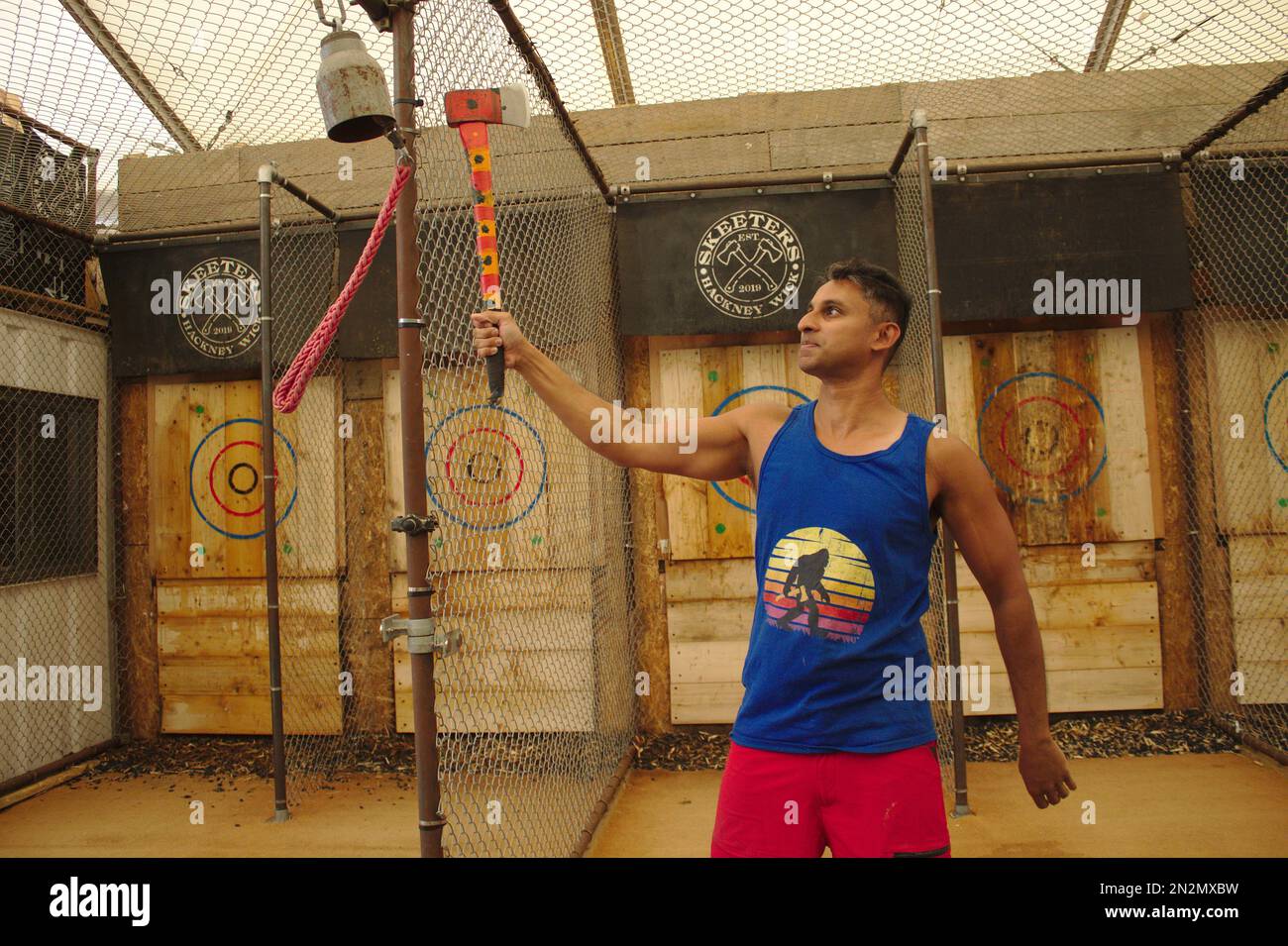 Axe throwing man Stock Photo - Alamy