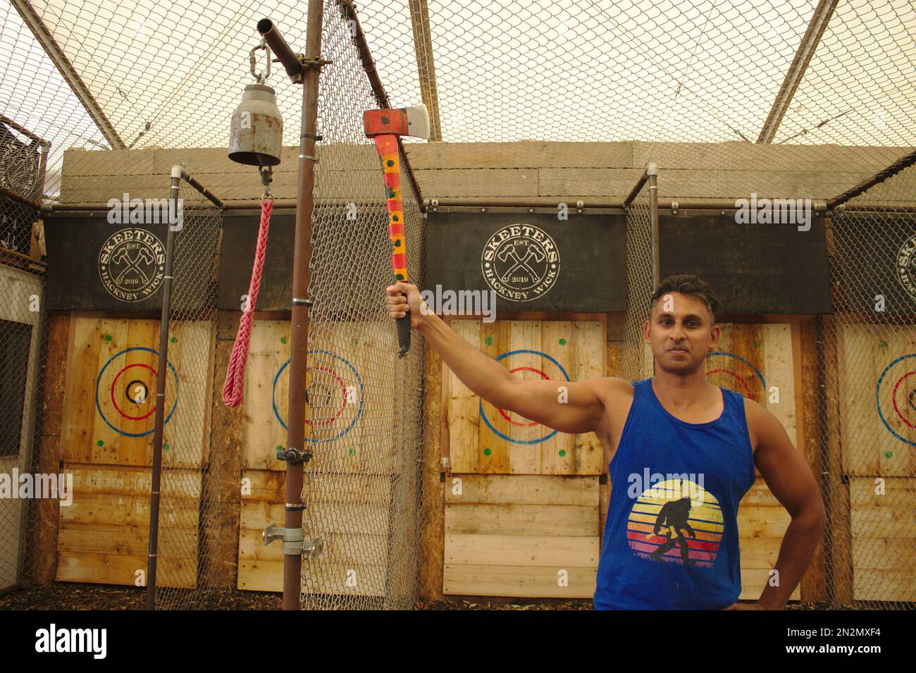 Axe throwing man Stock Photo - Alamy