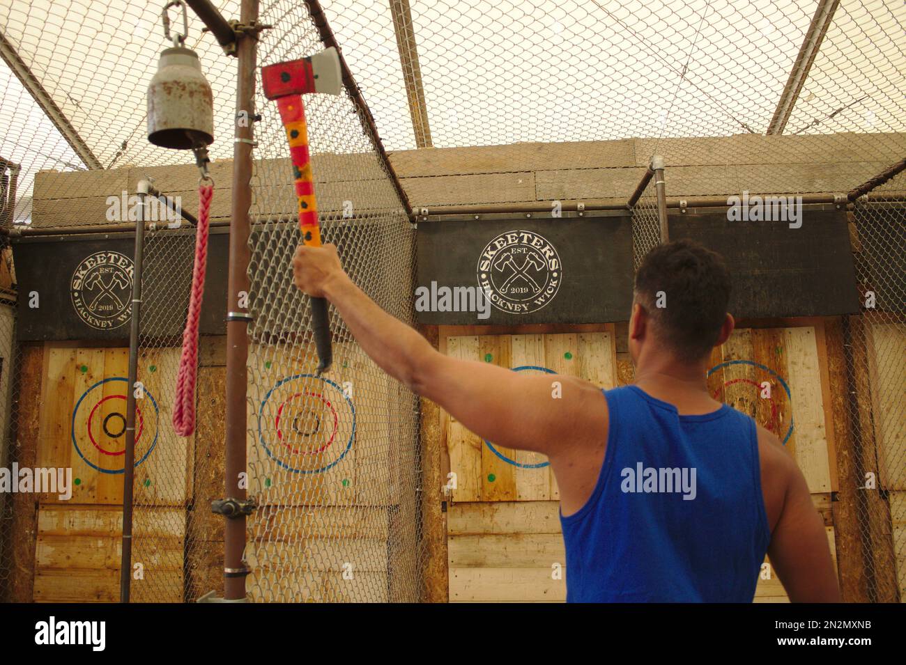Axe throwing man Stock Photo - Alamy