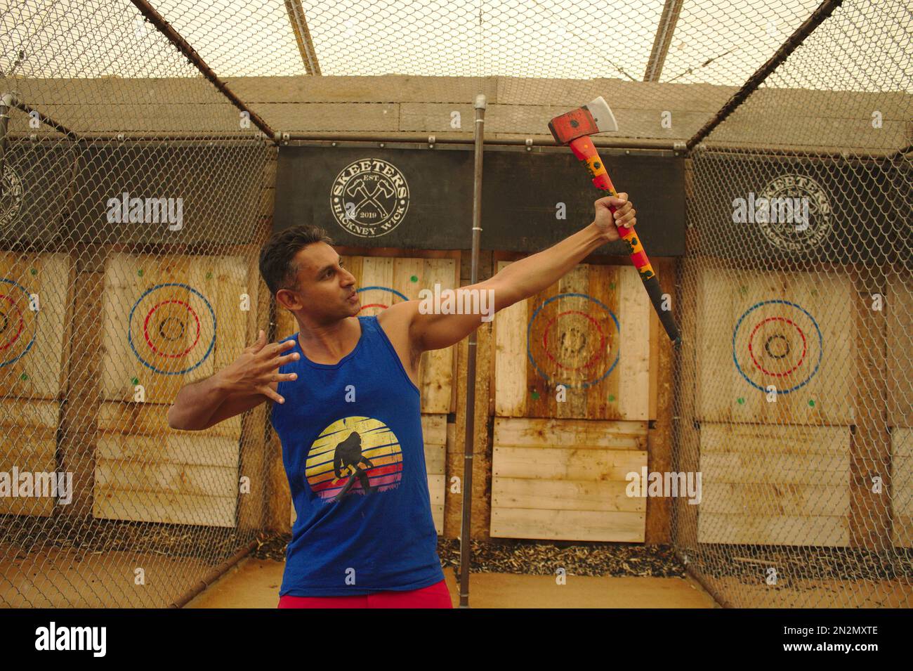 Axe throwing man Stock Photo - Alamy
