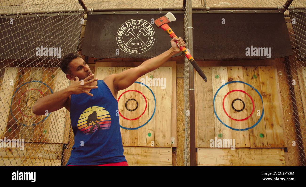 Axe throwing man Stock Photo - Alamy