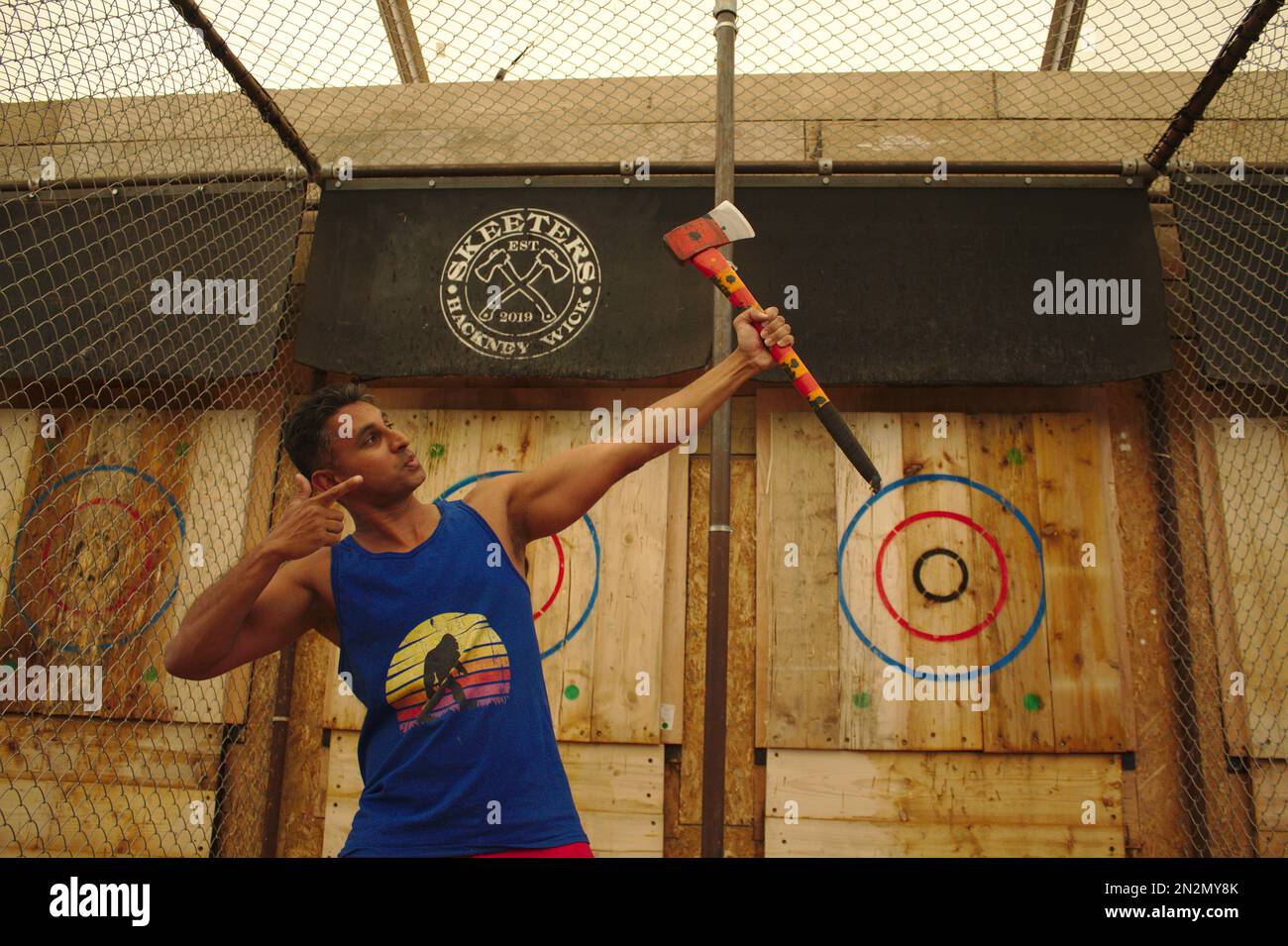 Axe throwing man Stock Photo - Alamy