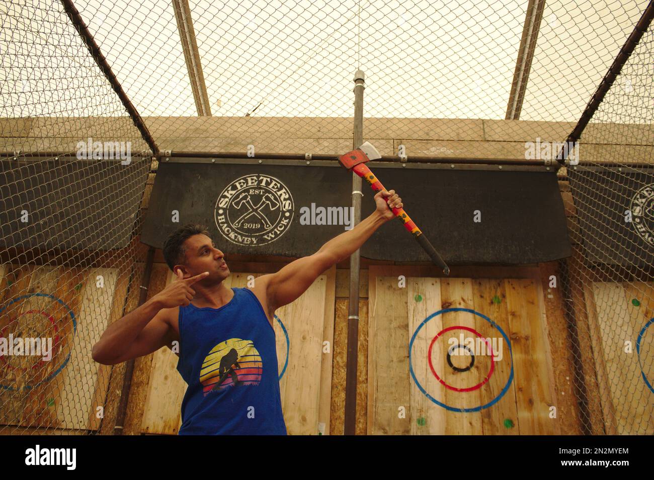 Axe throwing man Stock Photo - Alamy