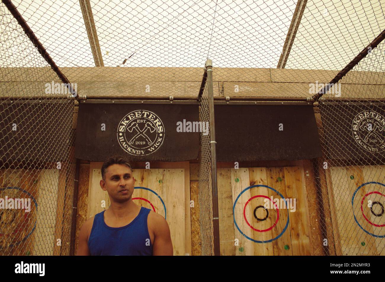 Axe throwing man Stock Photo - Alamy