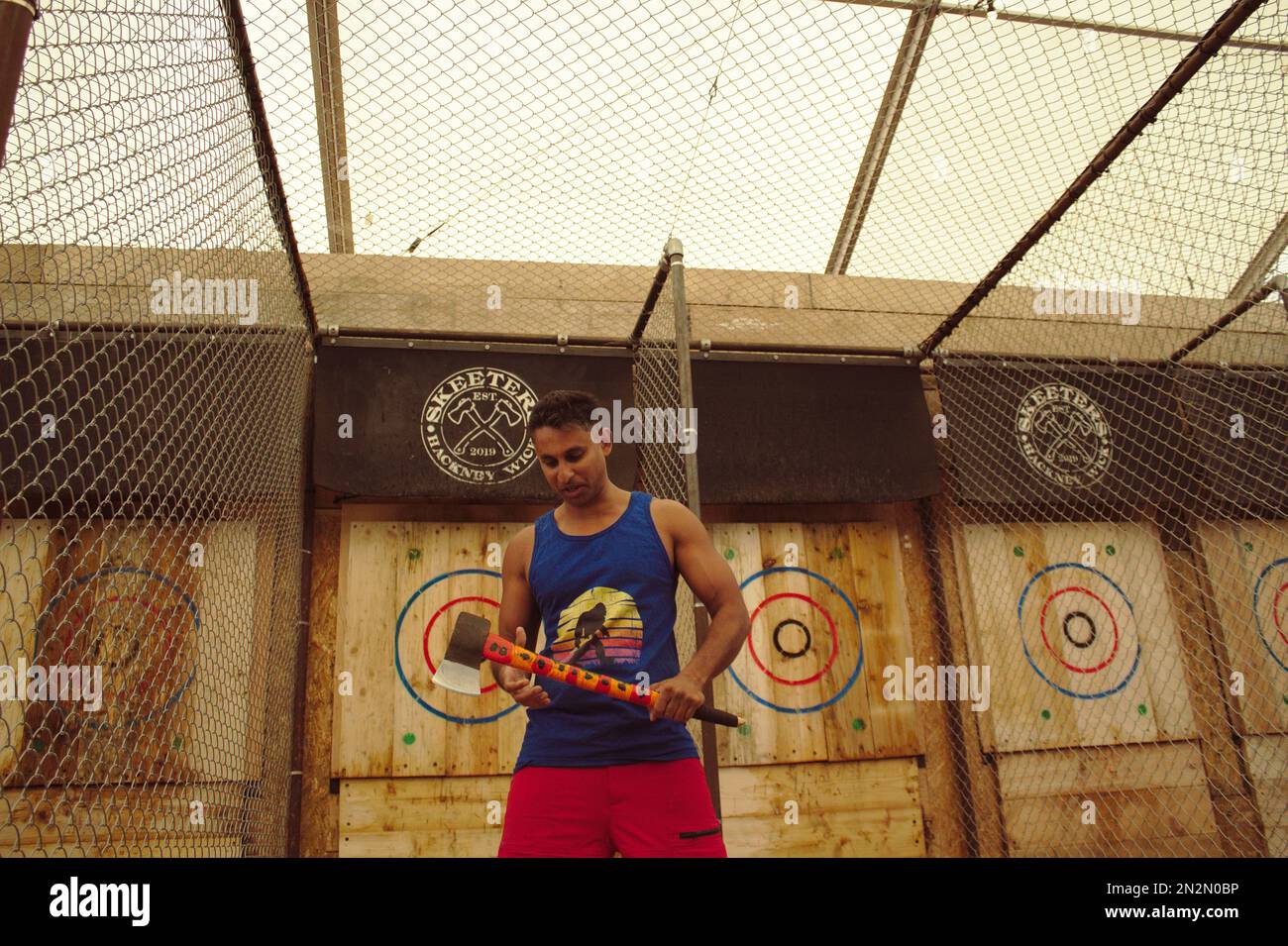 Axe throwing man Stock Photo - Alamy