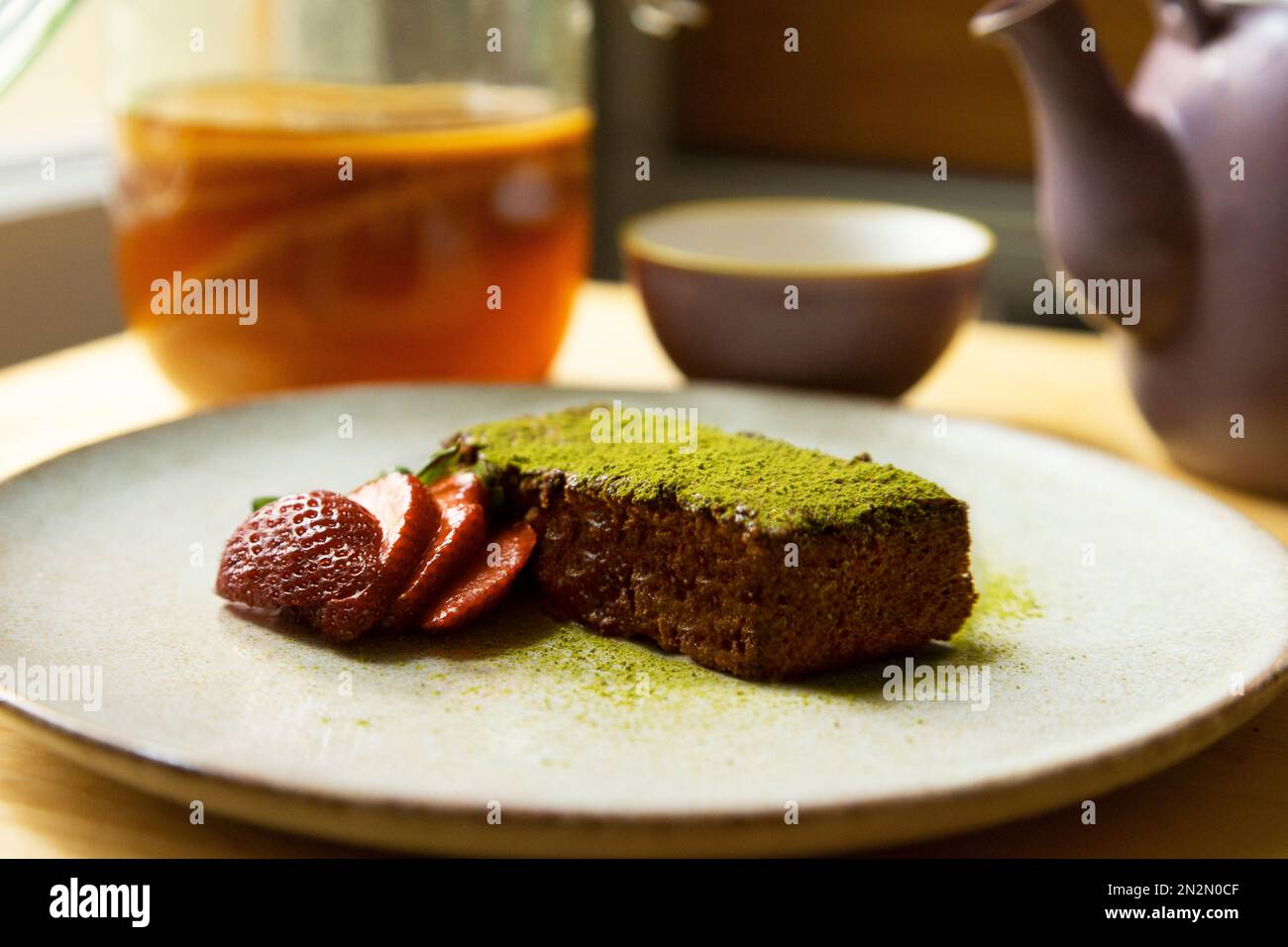 Portion of Soft Matcha Chocolate cake and combu tea Stock Photo - Alamy