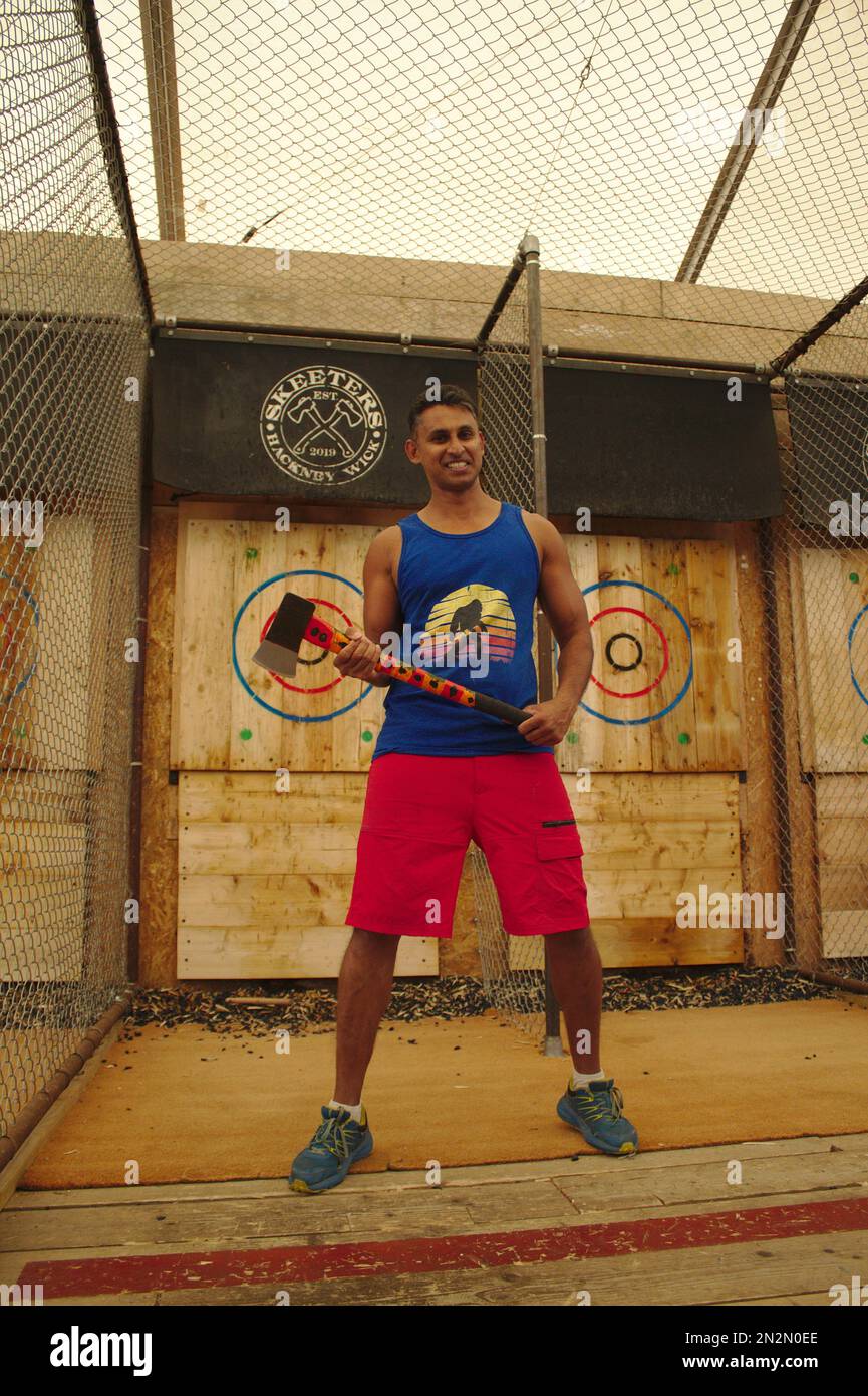 Axe throwing man Stock Photo - Alamy