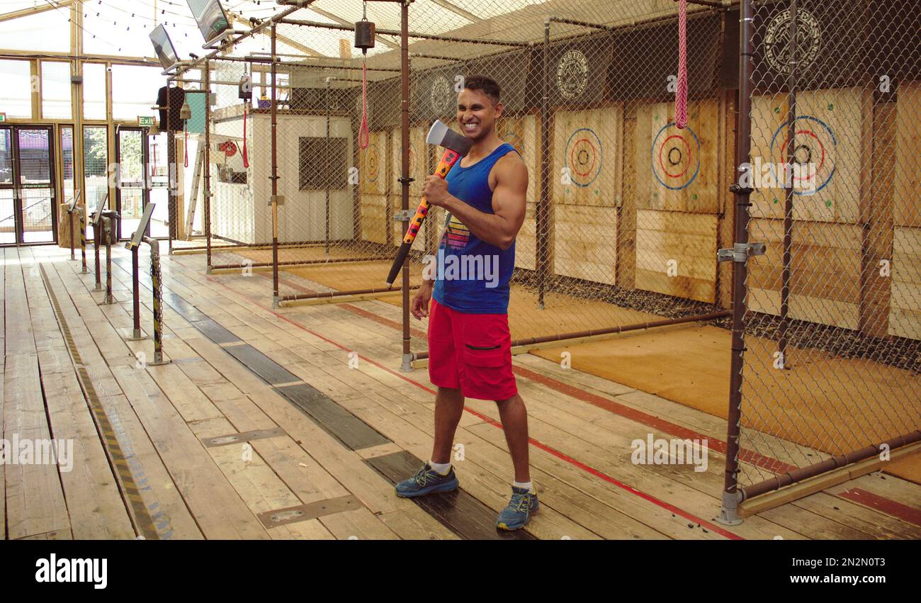 Axe throwing man Stock Photo - Alamy