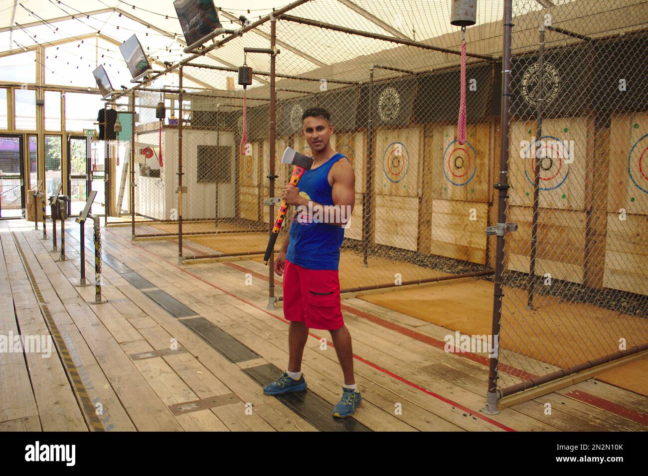 Axe throwing man Stock Photo - Alamy