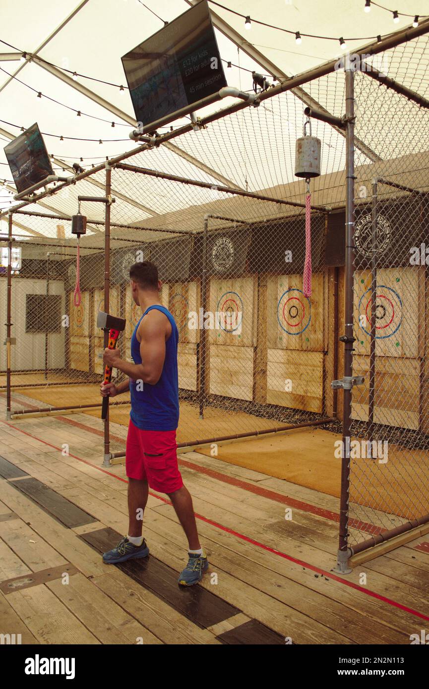 Axe throwing man Stock Photo - Alamy