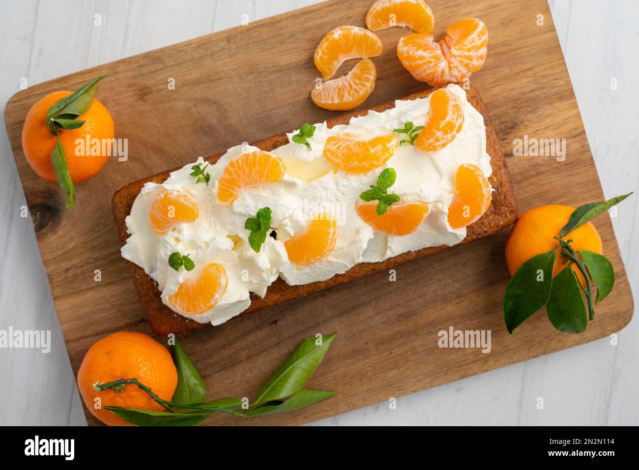 Carrot cake with cream frosting and tangerine pieces Stock Photo - Alamy